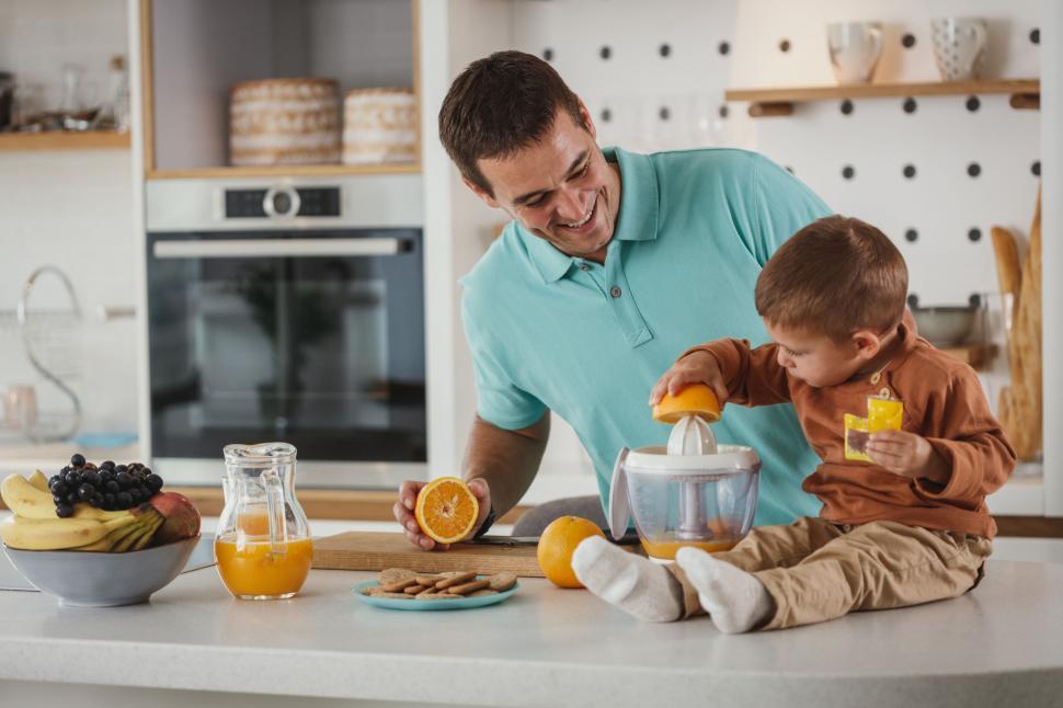 Free Stock Photo of Father and son making fresh juice together ...