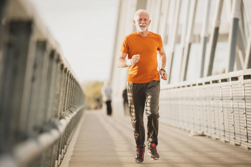 Free Stock Photo of Senior jogging on a sunny bridge pathway | Download ...