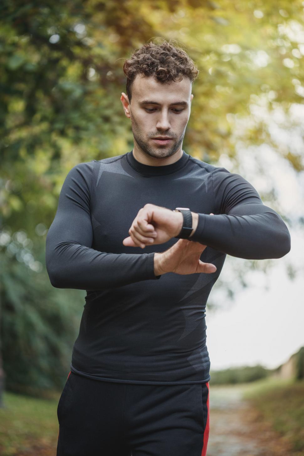 Free Stock Photo of Man checking smartwatch while exercising | Download ...