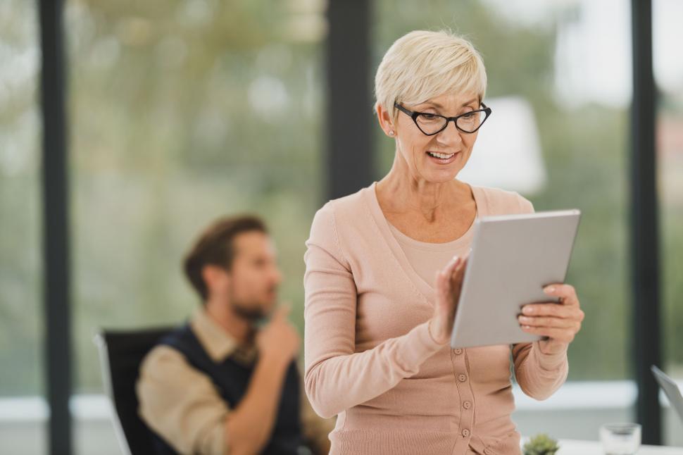 Free Stock Photo of Businesswoman using a tablet in an office ...