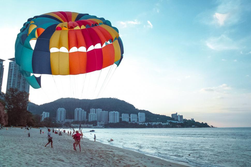 Free Stock Photo of Colorful parasailing against a sunset sky ...