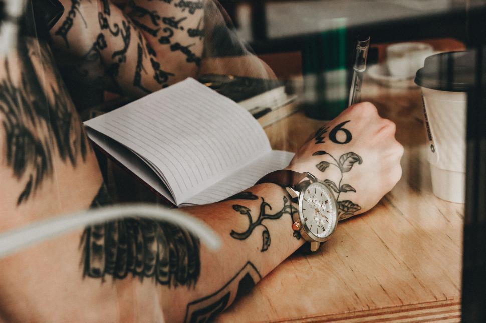 Free Stock Photo of Person writing in notebook with tattooed arms ...