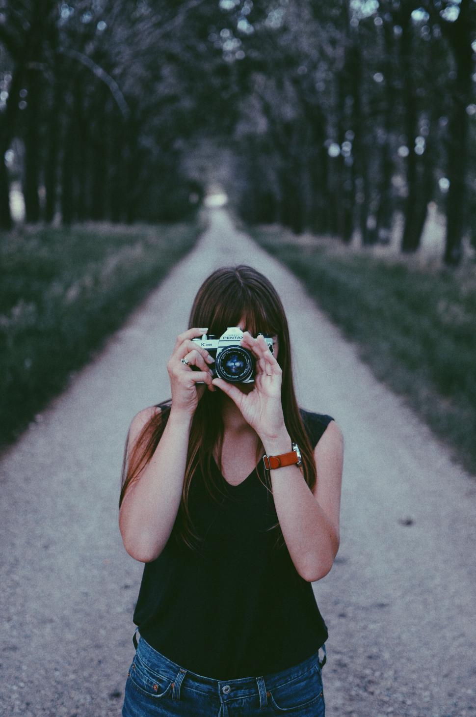 Free Stock Photo of Woman aiming camera at viewer down a path ...