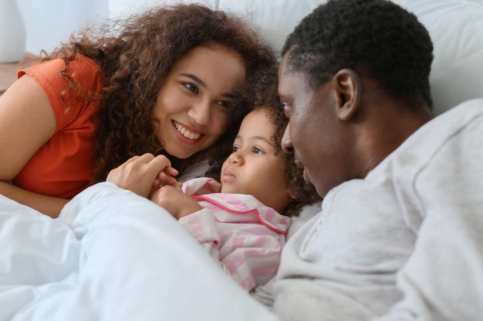 Free Stock Photo of Close-knit family sharing a moment in bed ...