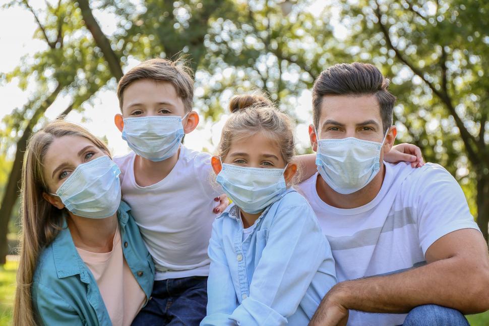 Free Stock Photo of Family with masks in a green park setting ...