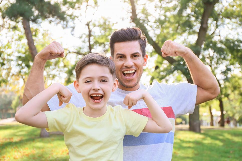 Free Stock Photo of Father and son showing off muscle strength ...