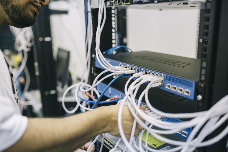 Free Stock Photo of Technician working on network server equipment ...