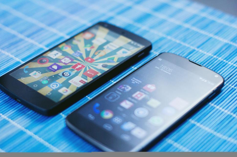 Free Stock Photo of Two smartphones displaying colorful wallpapers ...