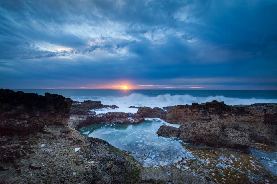 Free Stock Photo of Sunrise breaking the horizon at rocky beach ...