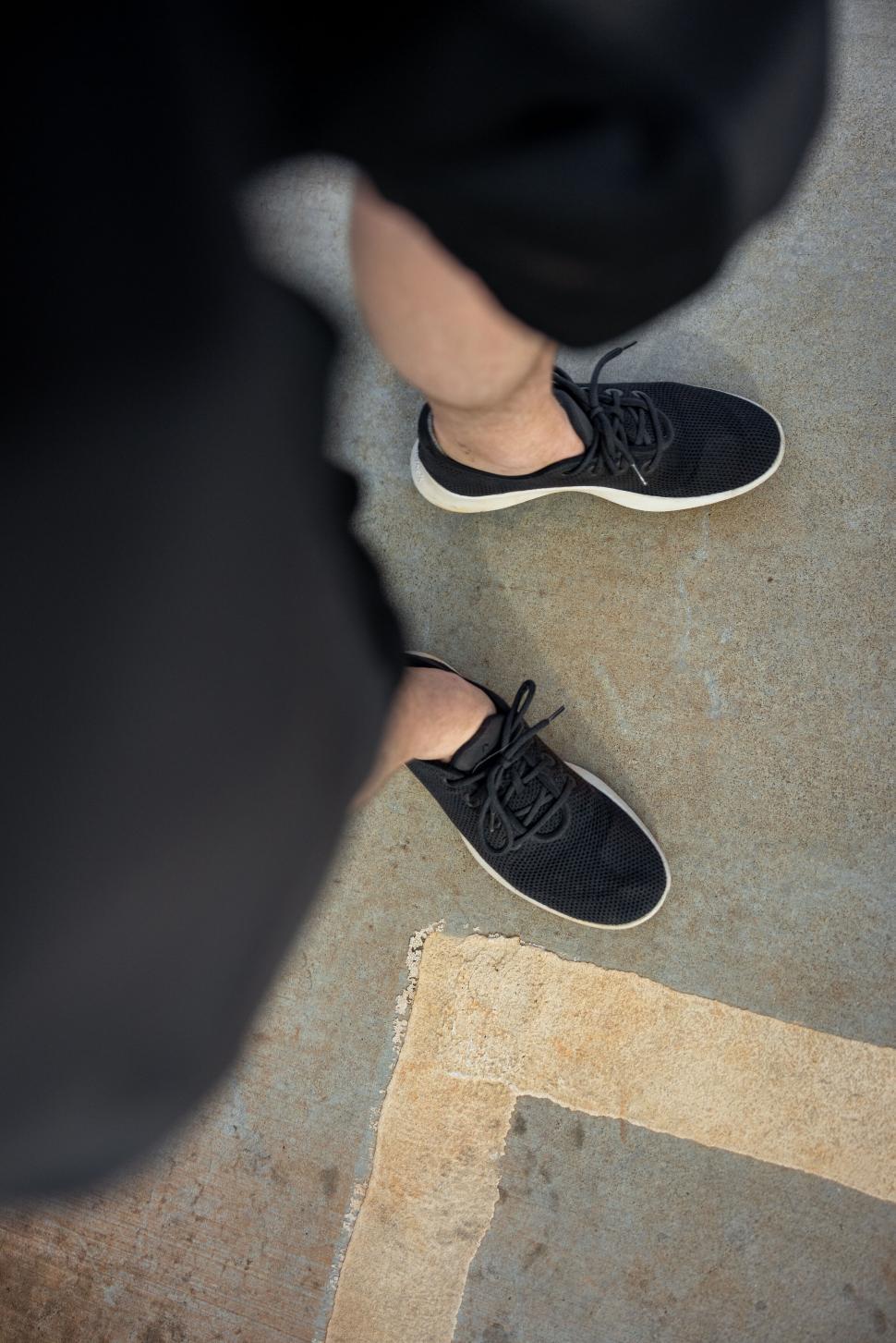 Free Stock Photo of Man s feet in black sneakers on pavement | Download ...