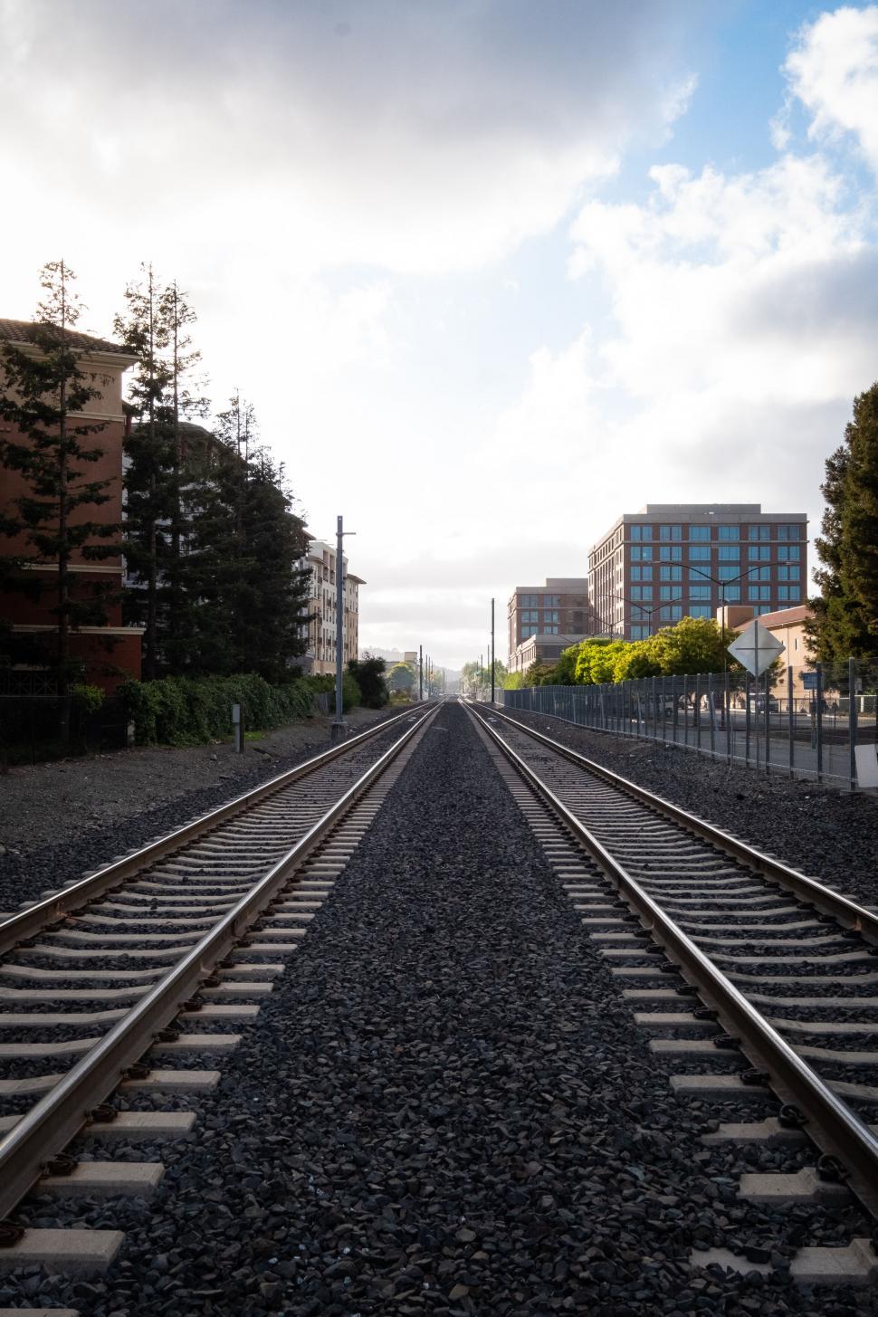 Free Stock Photo of Railroad tracks leading into urban skyline ...
