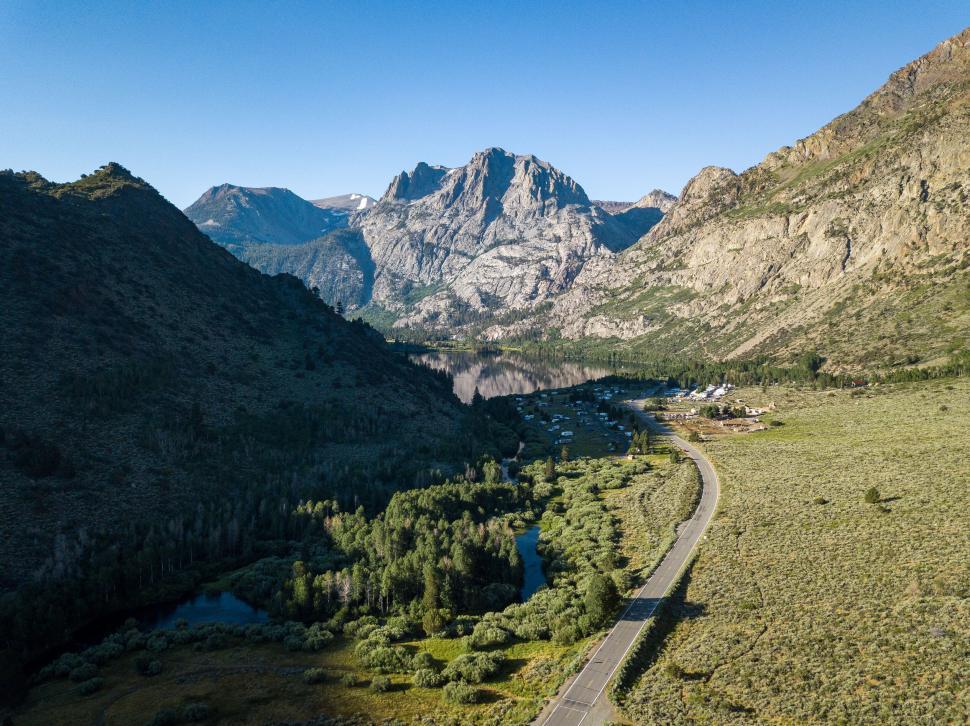 Free Stock Photo of Aerial view of a valley with a curvy road and lake ...