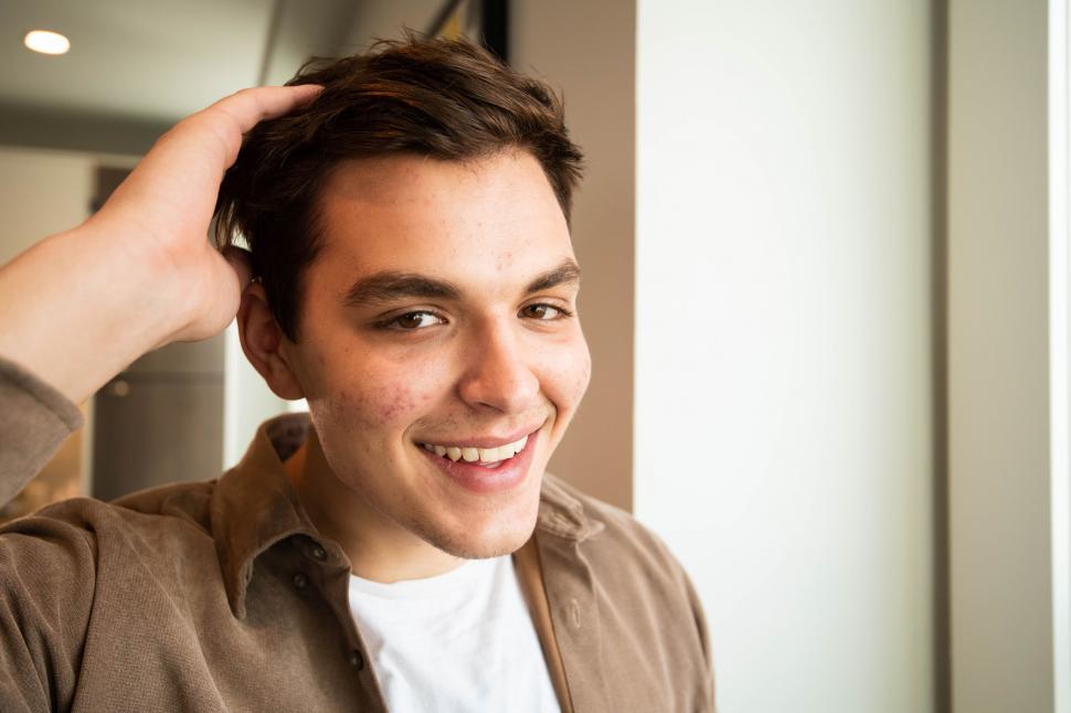 Free Stock Photo of Smiling young man scratching his head | Download ...