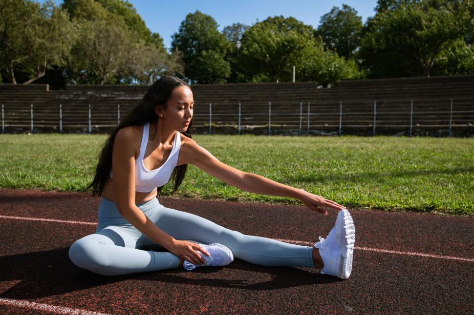 Free Stock Photo of Athlete stretching on a running track | Download ...