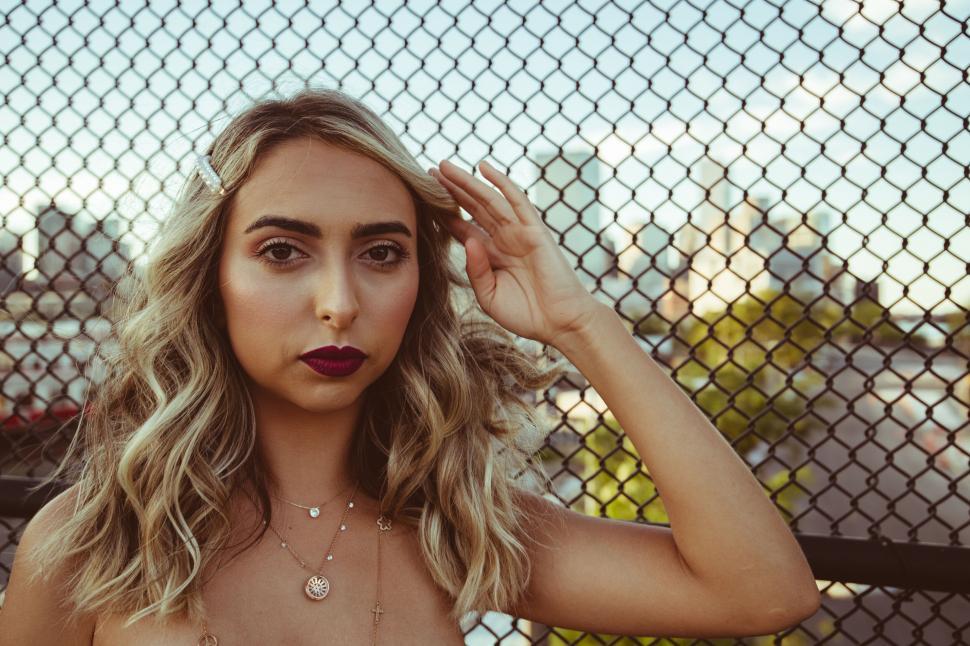 Free Stock Photo of Woman by fence at sunset with strong gaze ...