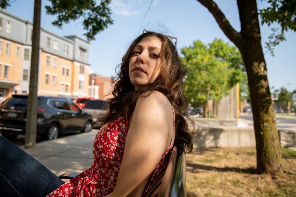 Free Stock Photo of Young woman sitting on park bench looking back ...