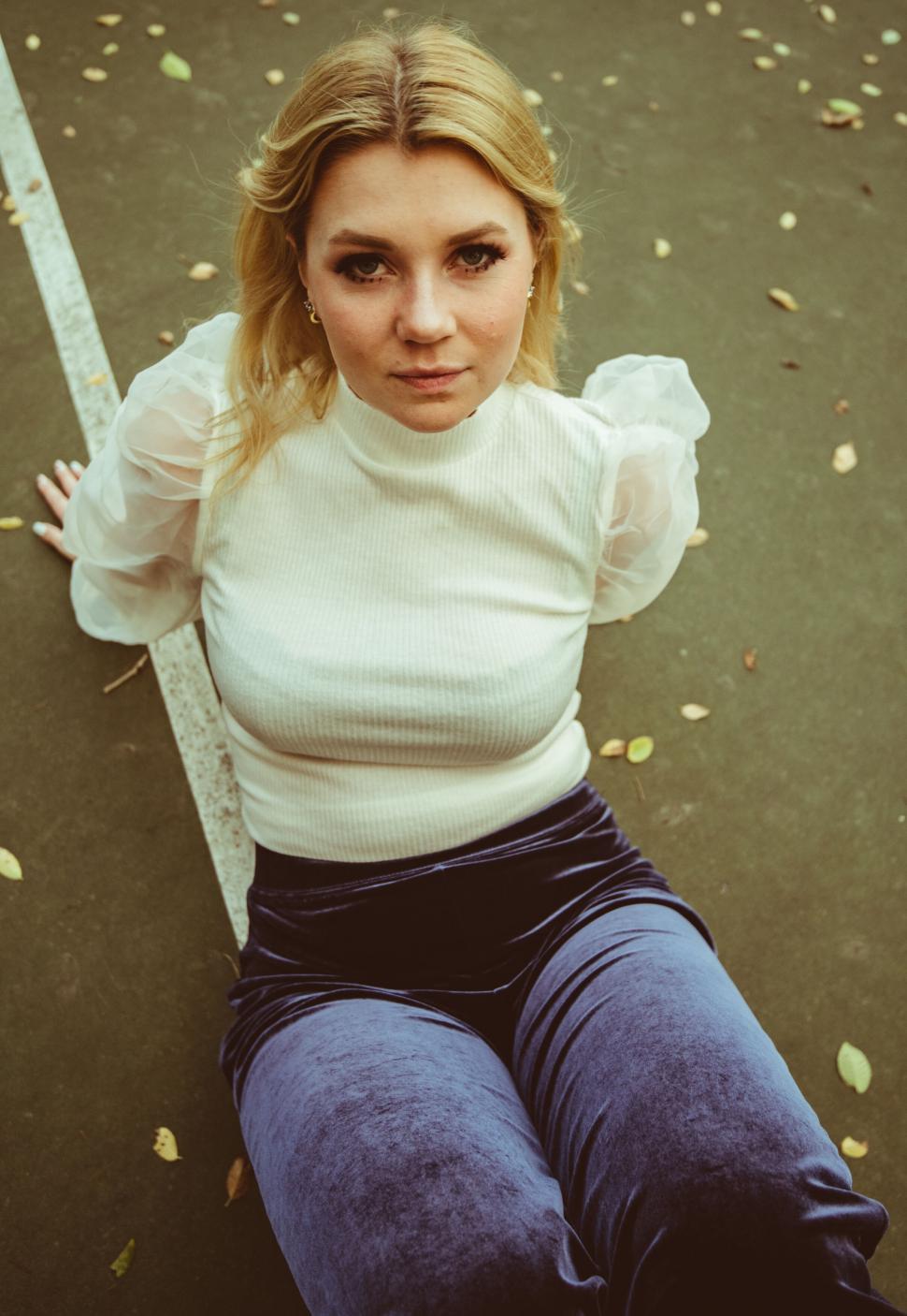 Free Stock Photo of Young woman sitting with a modern backdrop ...