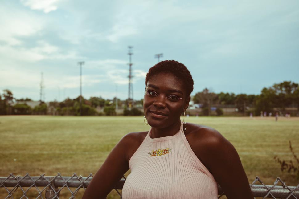 Free Stock Photo of Smiling woman near a chain-link fence | Download ...