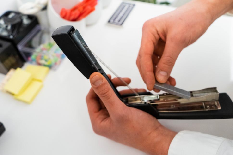Free Stock Photo of Man loading staple gun casually at work | Download ...