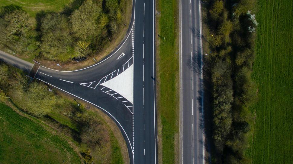 Free Stock Photo of Aerial view of a road splitting green fields ...