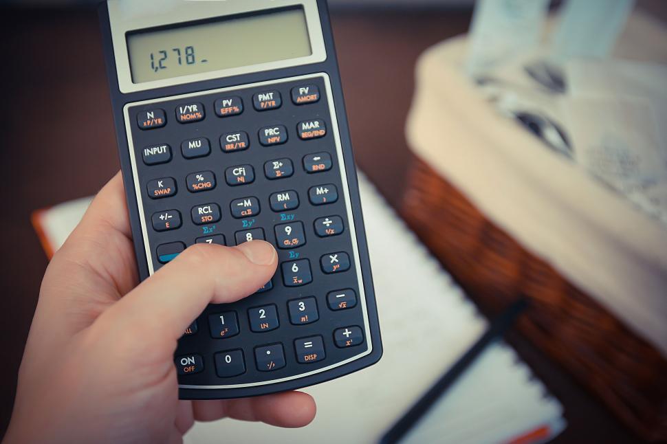 Free Stock Photo of Hand holding calculator with visible amount ...