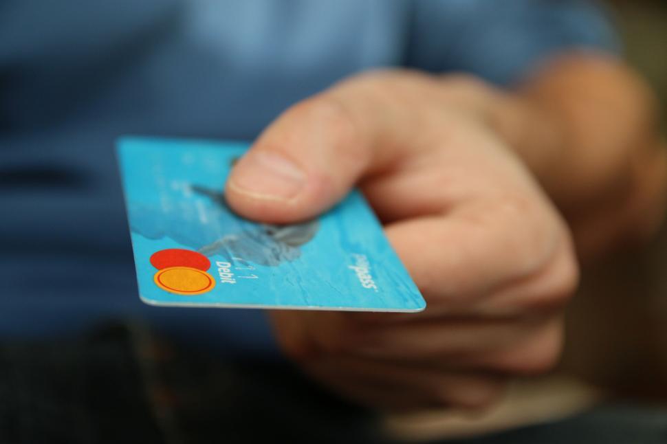 Free Stock Photo of Blurred credit card in hand emphasis on card ...