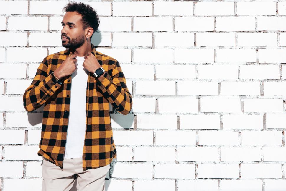 Free Stock Photo of A man standing against a white brick wall ...