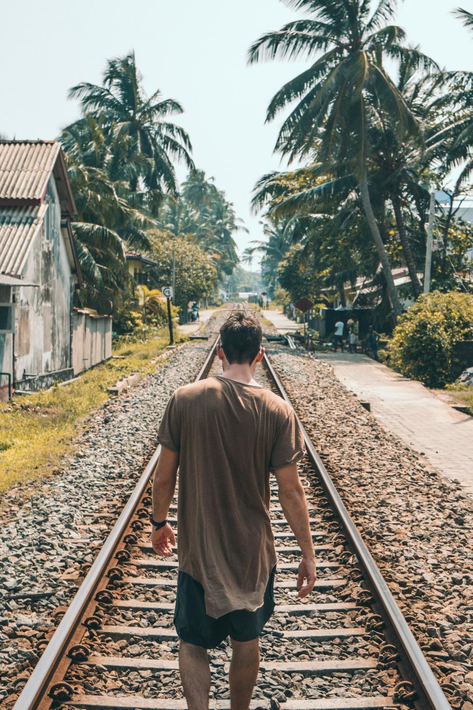 Free Stock Photo of Man walking along tropical railway tracks ...