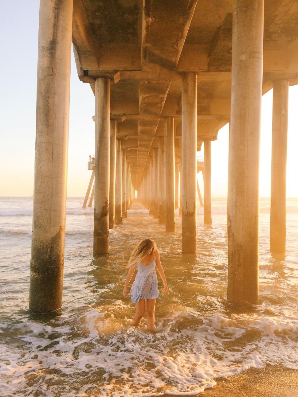 Free Stock Photo of Girl walking under pier with sunset light ...