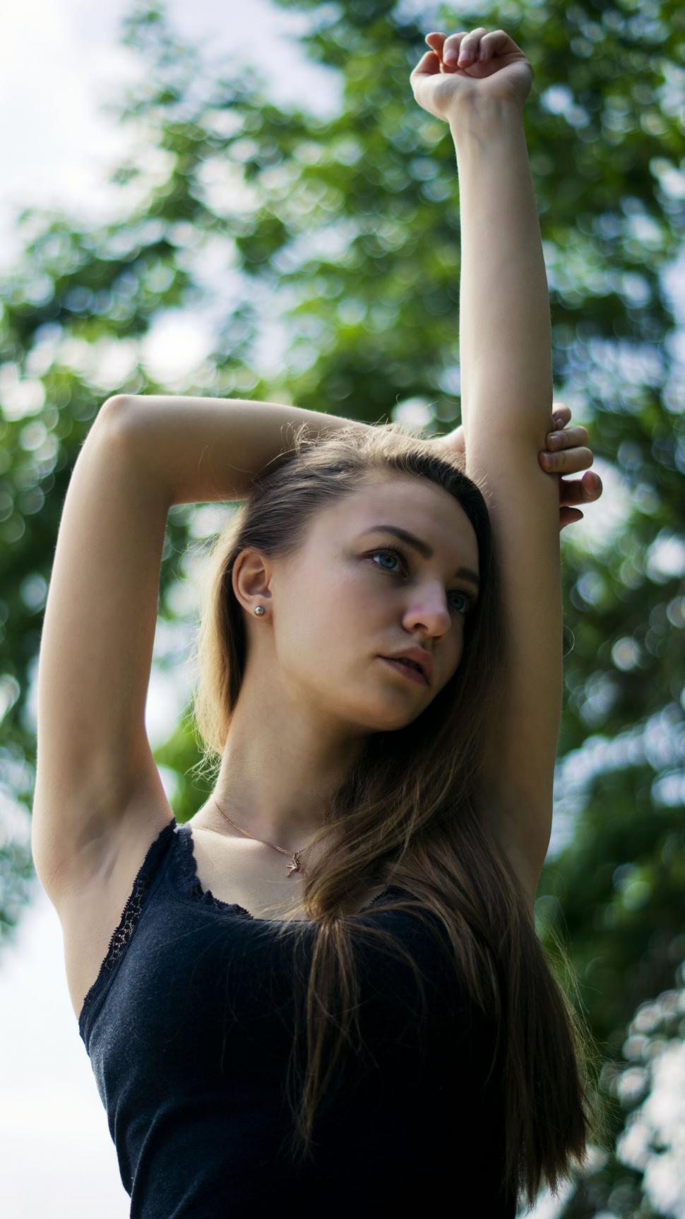 Free Stock Photo of Woman stretching arm against green foliage ...