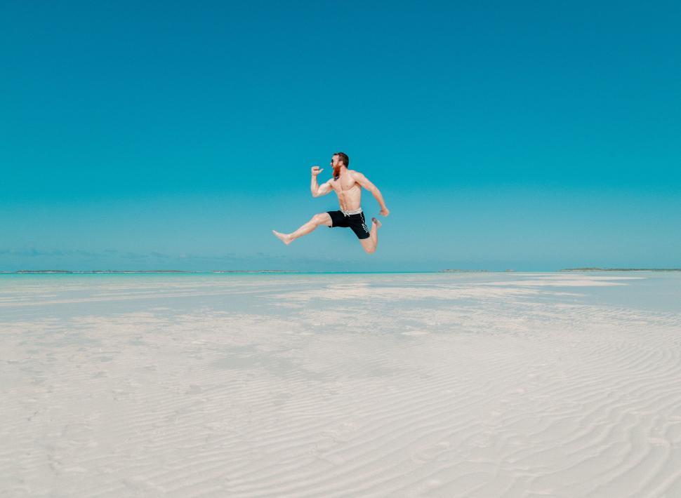Free Stock Photo of Man jumping over deserted white sands | Download ...