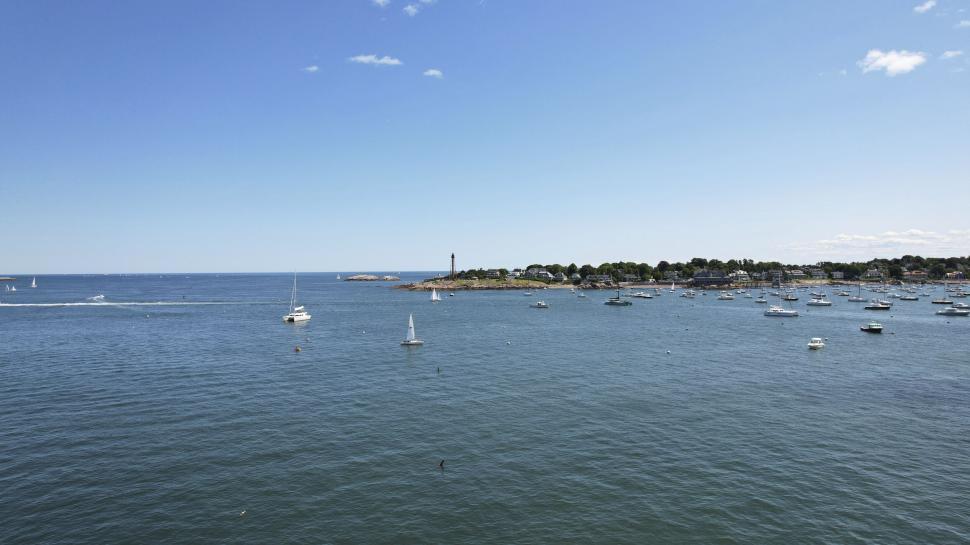 Free Stock Photo of Busy coastal harbor with boats, lighthouse and blue ...