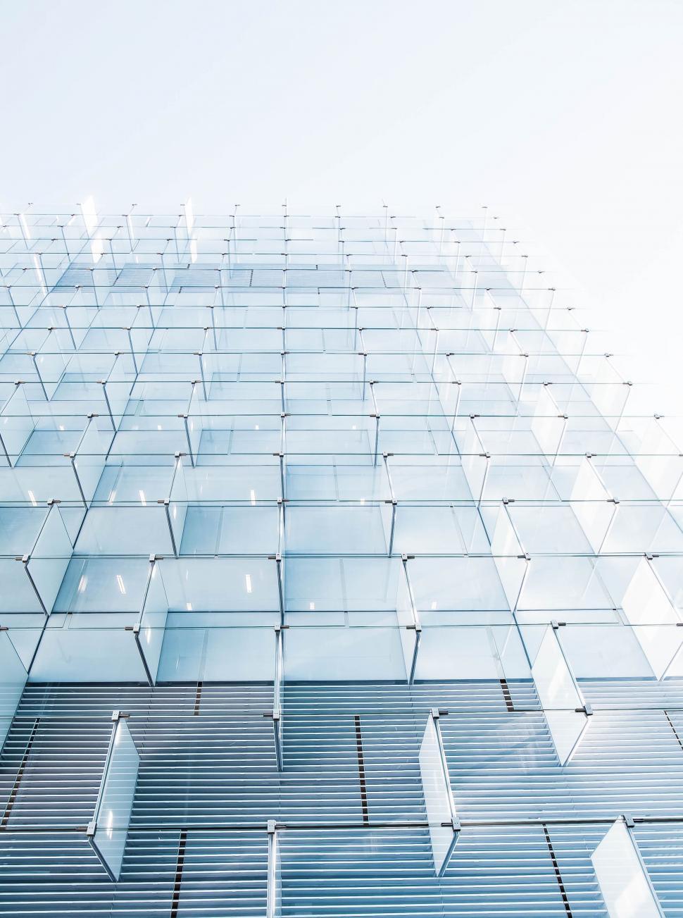 Free Stock Photo of High-rise glass building with open panels and blue ...
