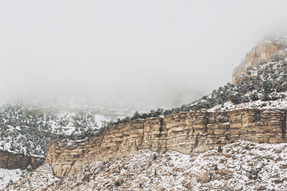 Free Stock Photo of Rocky cliff with snow-covered landscape under ...