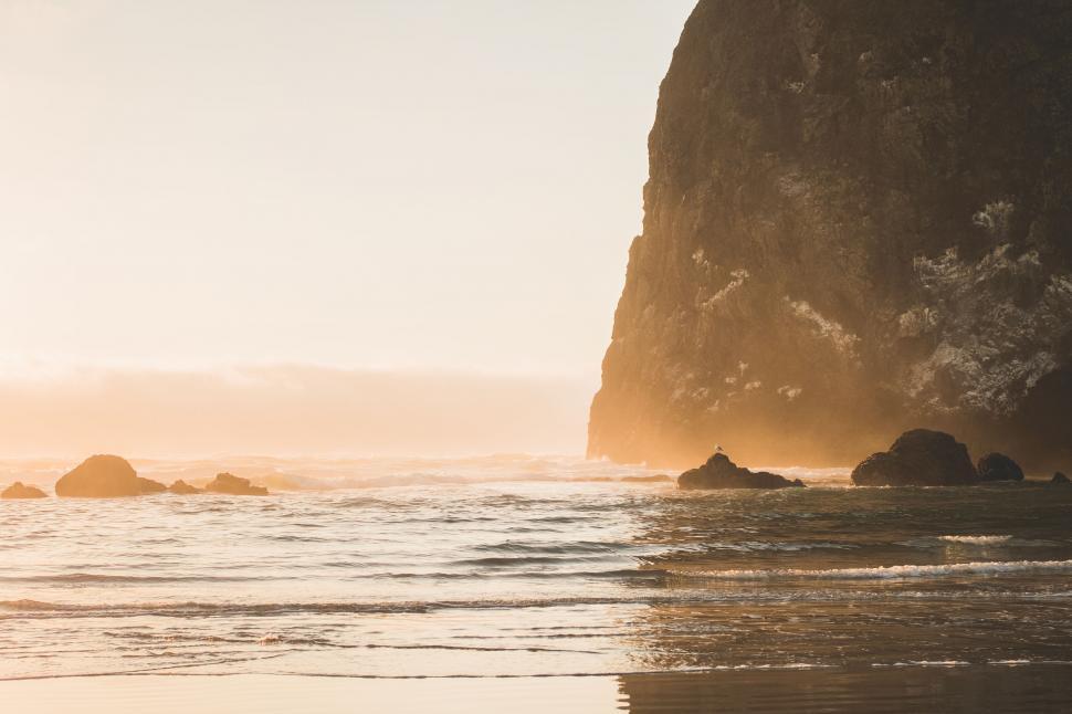 Free Stock Photo of Sunset at rocky beach with large cliff and calm ...
