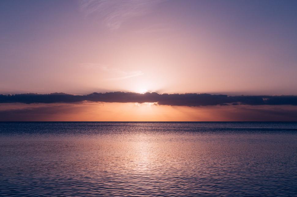 Free Stock Photo of Tranquil sunrise over calm ocean with colorful sky ...