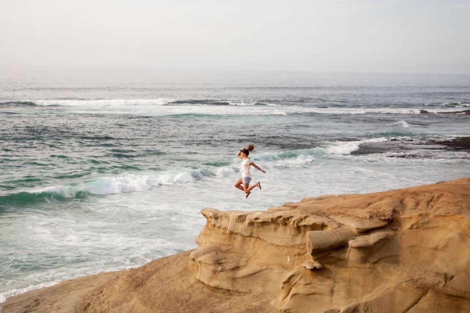 Free Stock Photo of Person jumping off rock cliff over ocean waves ...
