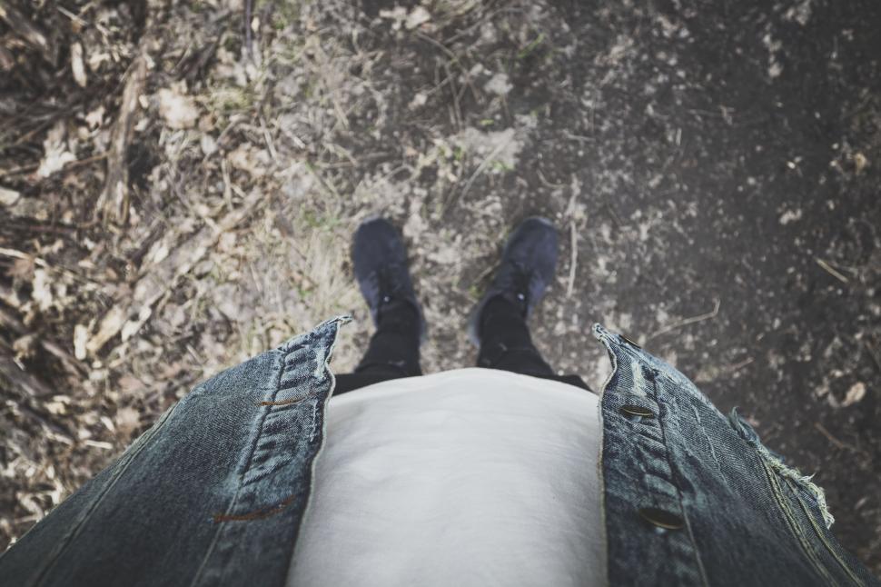Free Stock Photo of Point of view shot looking down at worn jeans and ...