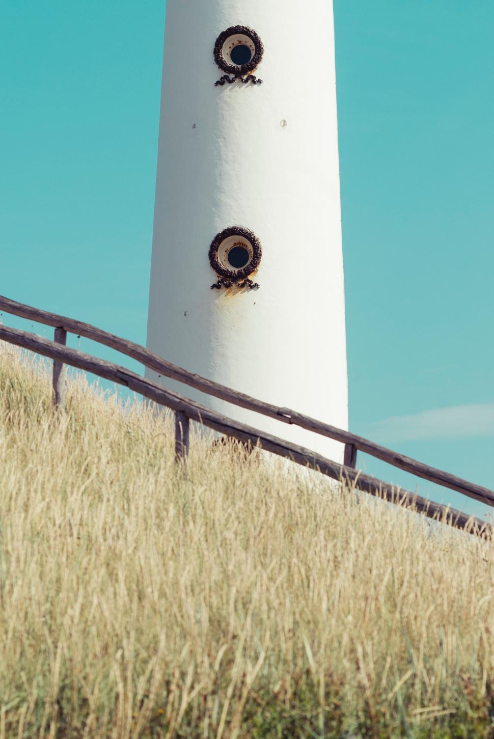 Free Stock Photo of Tall white lighthouse with a wooden railing against ...