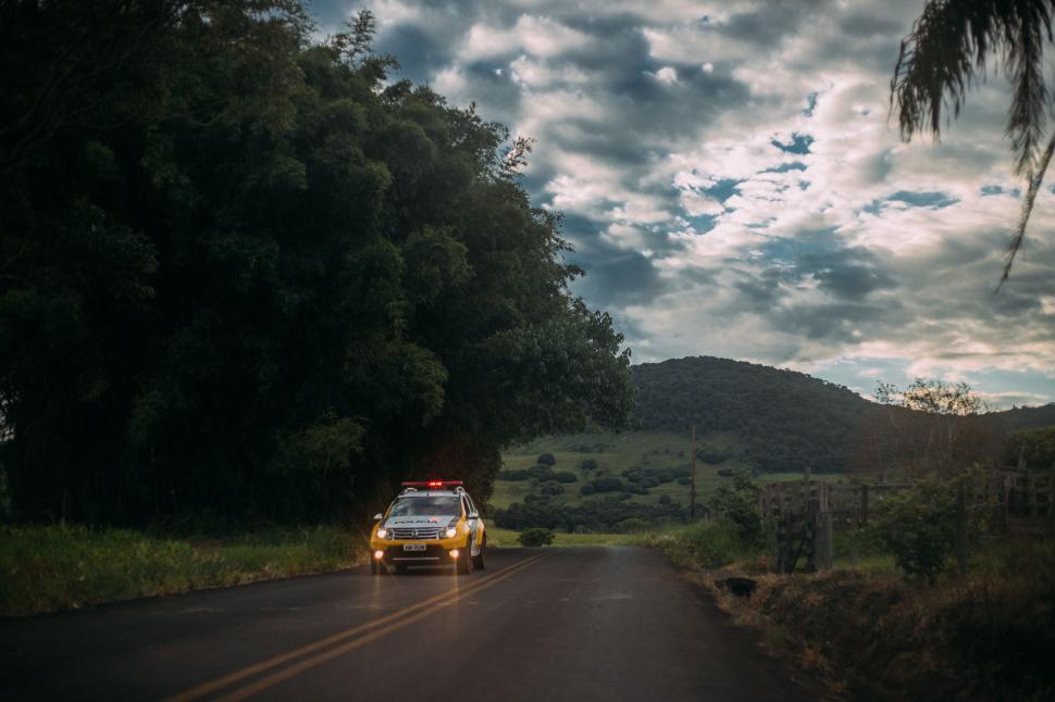 Free Stock Photo of Police car with lights on driving down a rural road ...