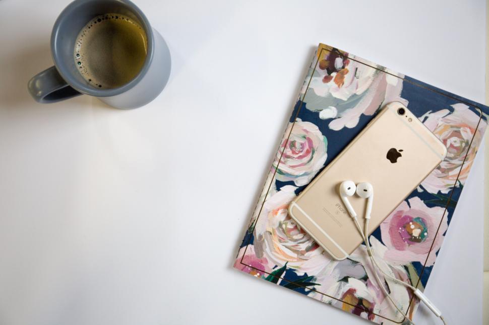 Free Stock Photo of Smartphone and earphones on floral planner beside ...