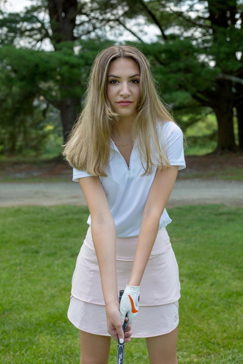 Free Stock Photo of Woman golfer preparing to swing on a lush golf ...