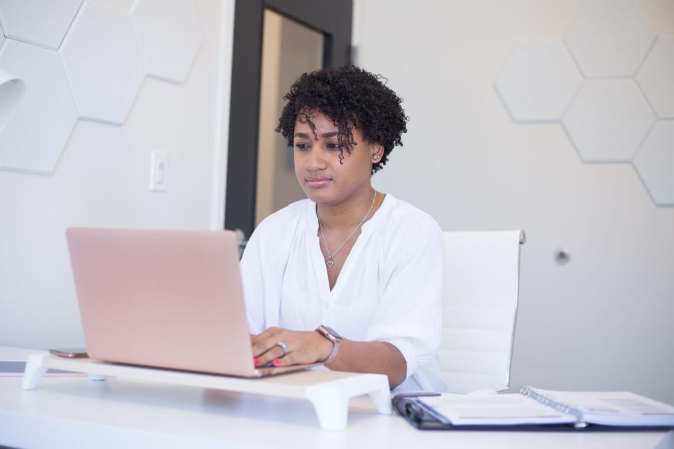 Free Stock Photo of Focused woman working on a laptop in a modern ...