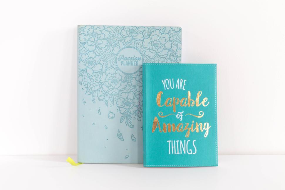 Free Stock Photo of Two teal notebooks on a white surface with ...