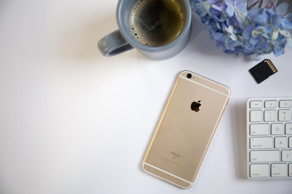 Free Stock Photo of Golden iPhone, coffee, keyboard, and flowers on a ...