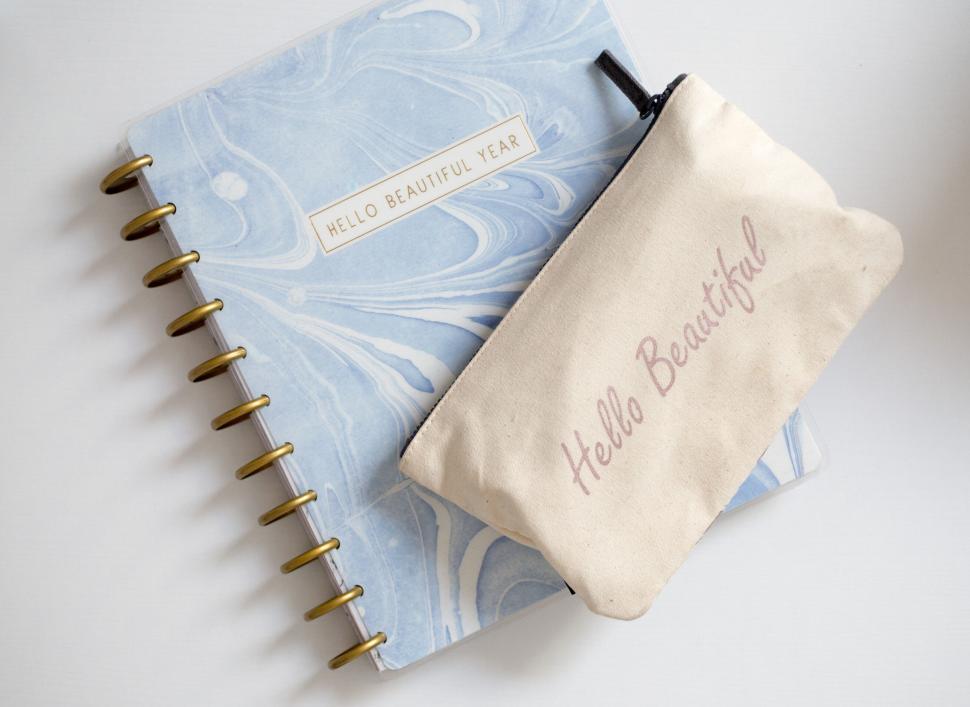 Free Stock Photo of Journal and pouch with text hello beautiful year on ...