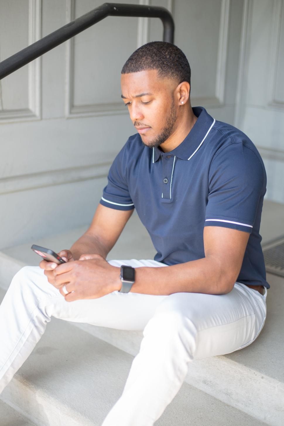 Free Stock Photo of Man sitting on stairs using smartphone in urban ...