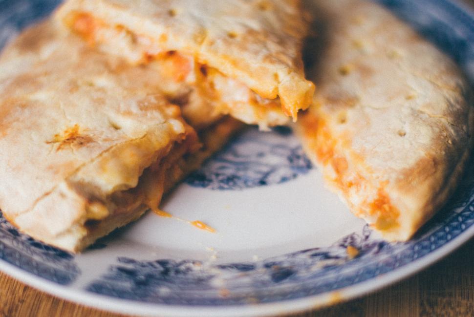 Free Stock Photo of Sliced cheesy calzone with visible fillings on a ...