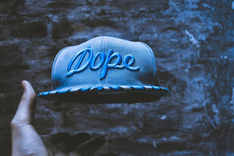 Free Stock Photo of Grey cap with Dope text written on it held by one ...