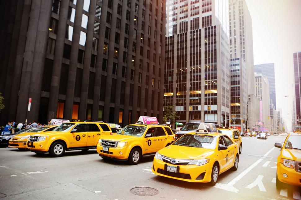 Free Stock Photo of Line of yellow taxis driving through the busy city ...